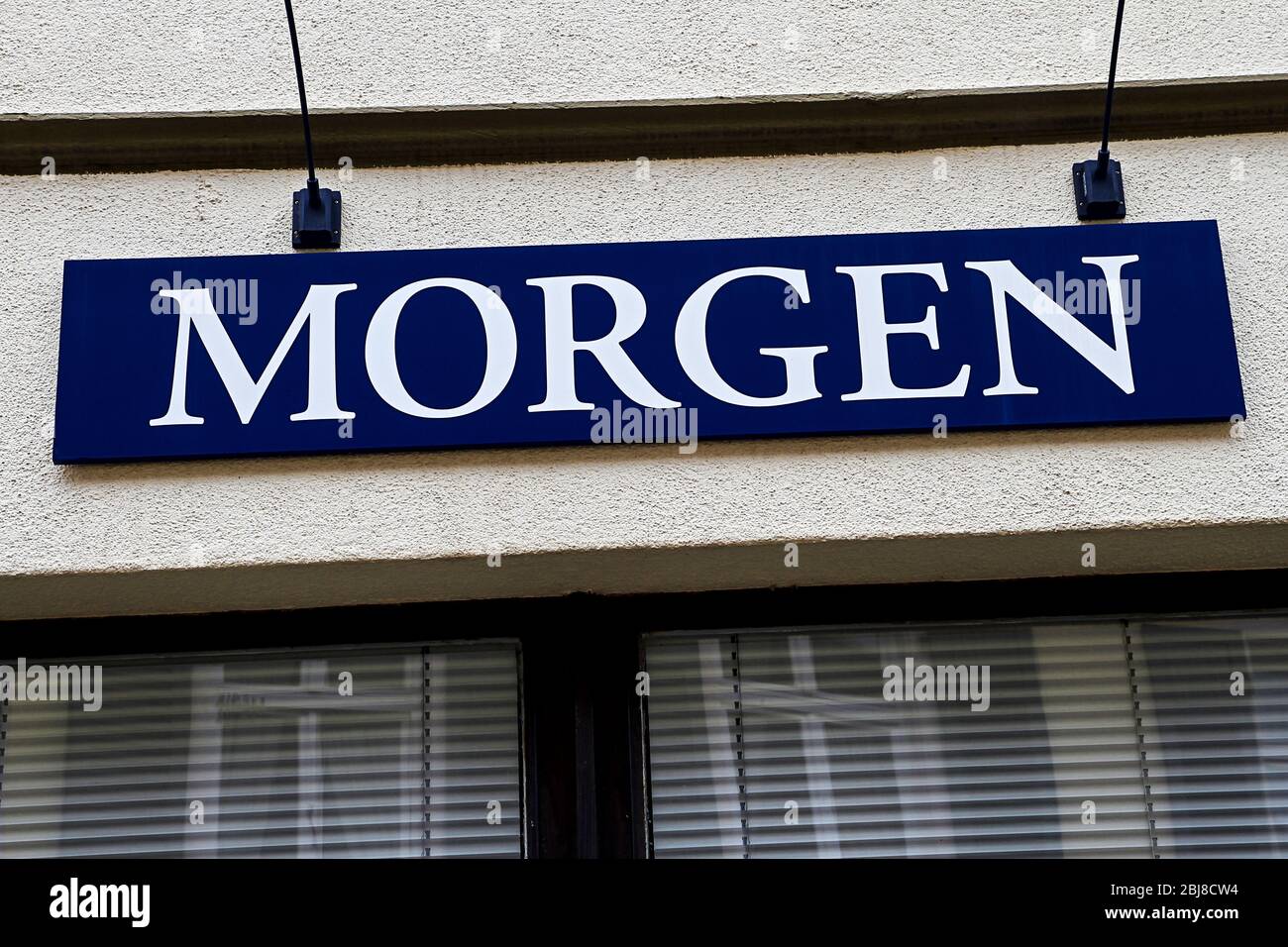 white capital letters saying Morgen in german language, in english ...