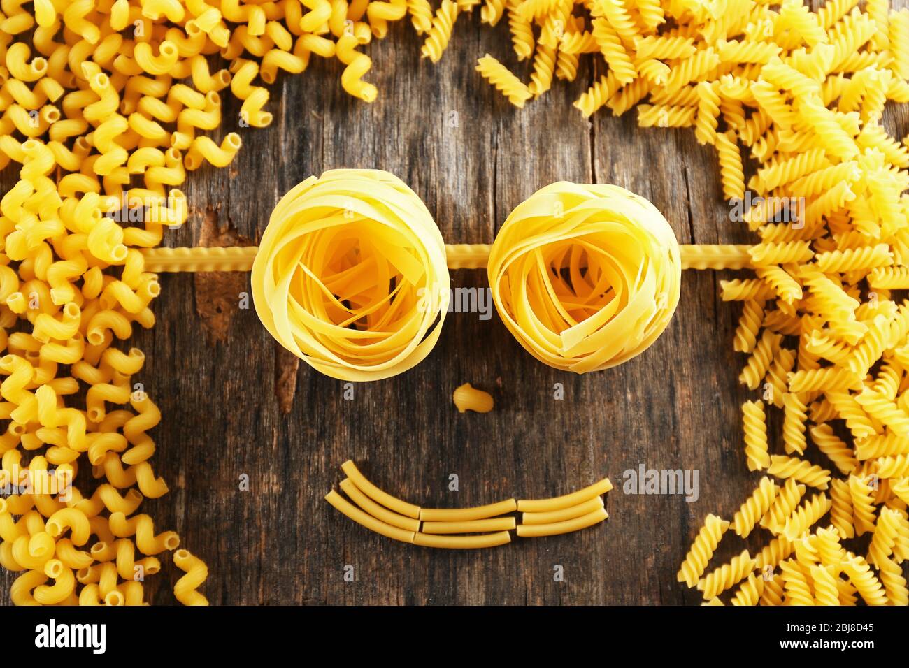 Raw pasta in shape of face Stock Photo - Alamy