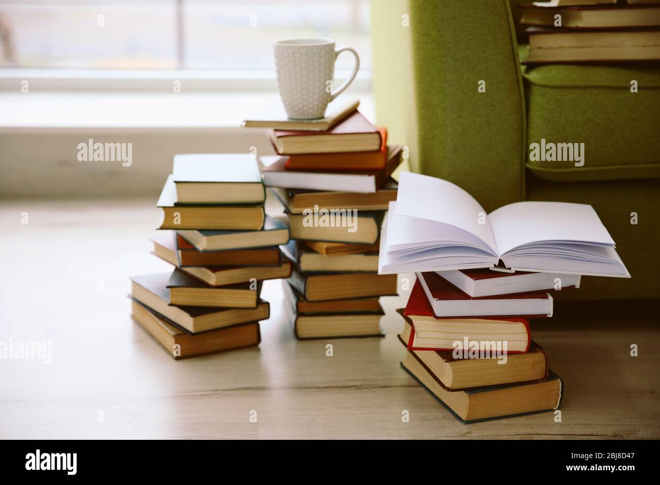 Pile of books on floor at home Stock Photo - Alamy