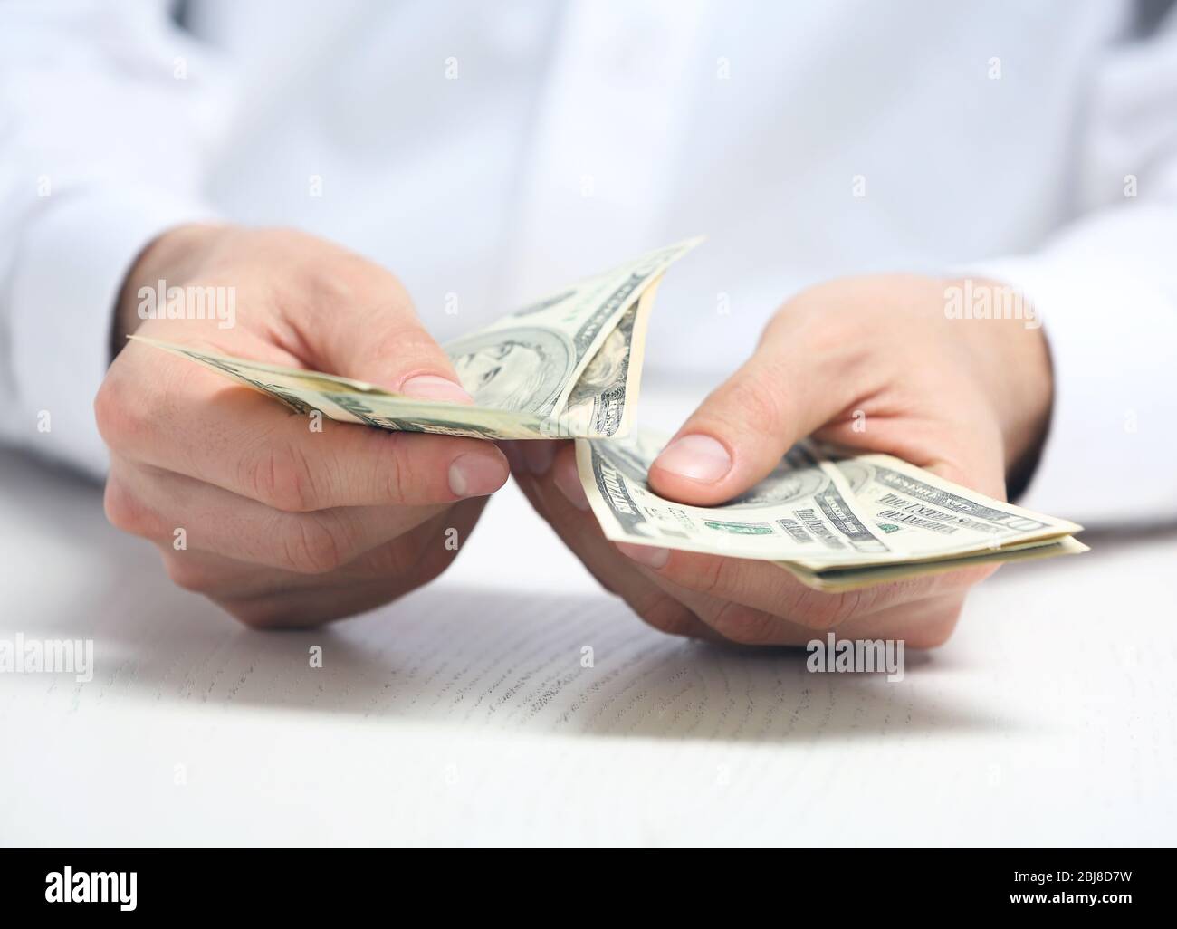 Man counting money and making calculations Stock Photo - Alamy