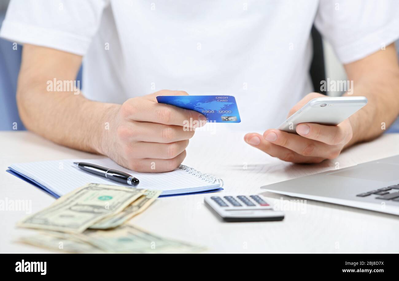 Man counting money and making calculations Stock Photo - Alamy