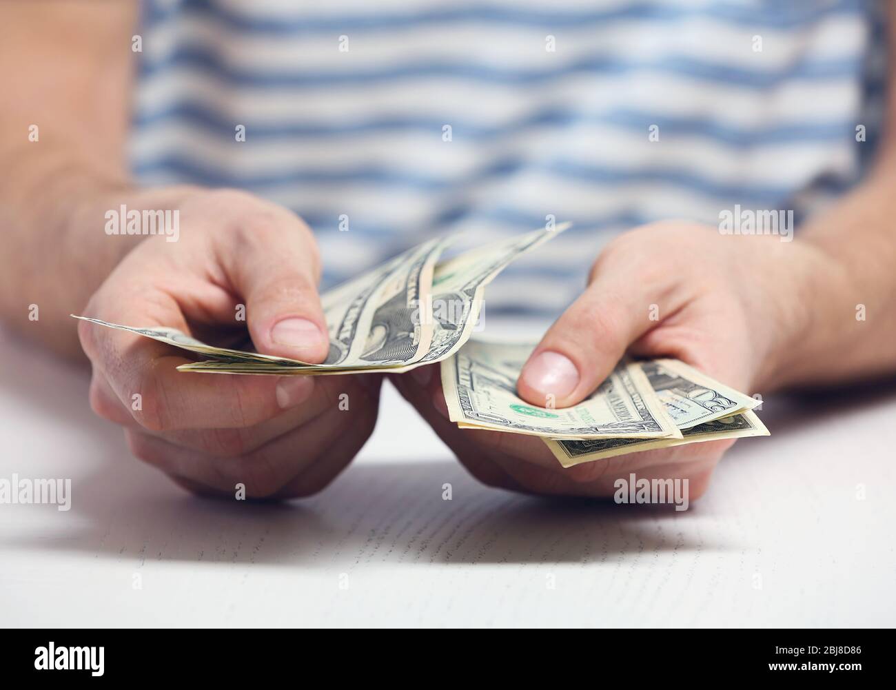 Man counting money and making calculations Stock Photo - Alamy