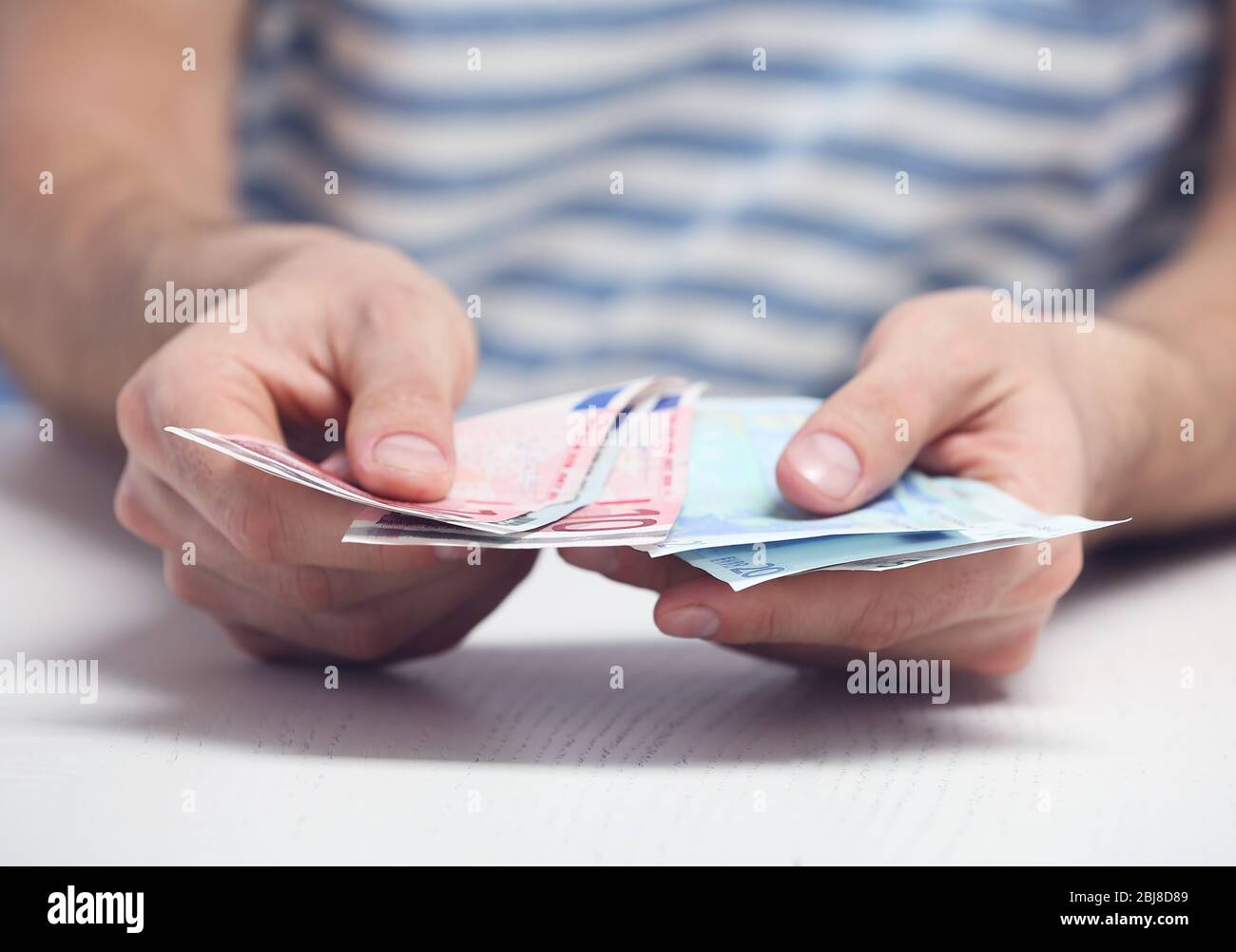 Man counting money and making calculations Stock Photo - Alamy