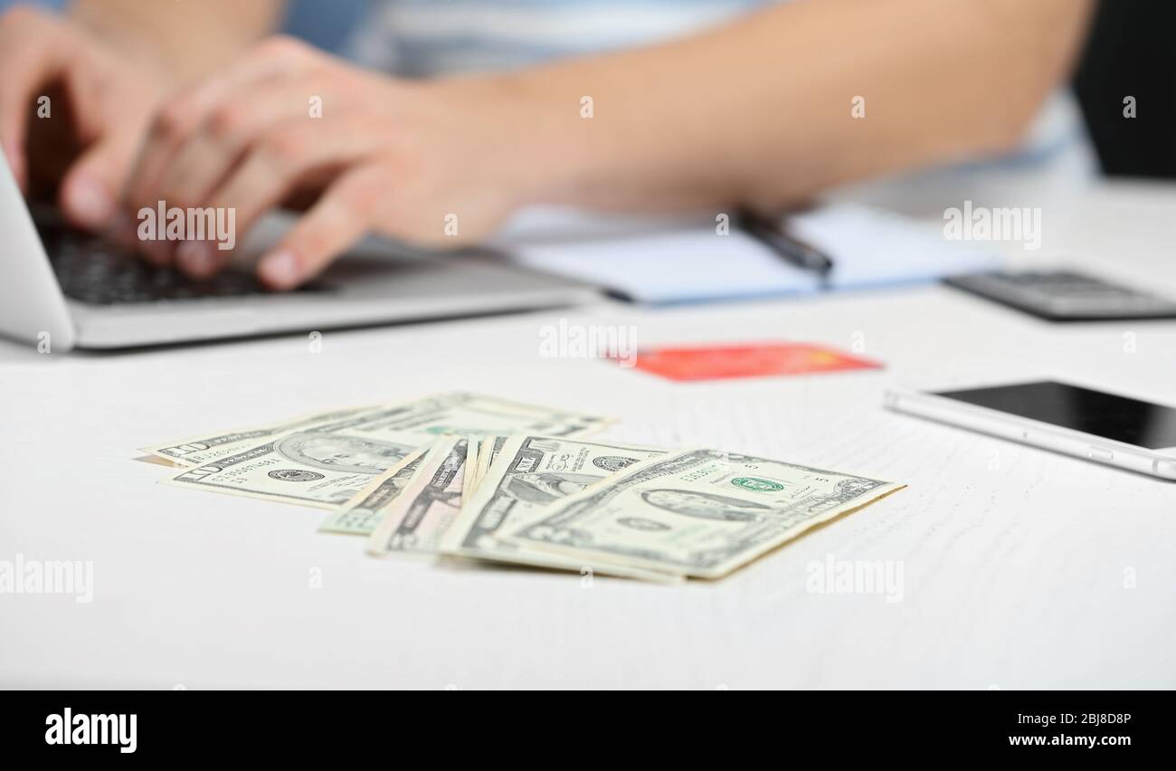 Man counting money and making calculations Stock Photo - Alamy