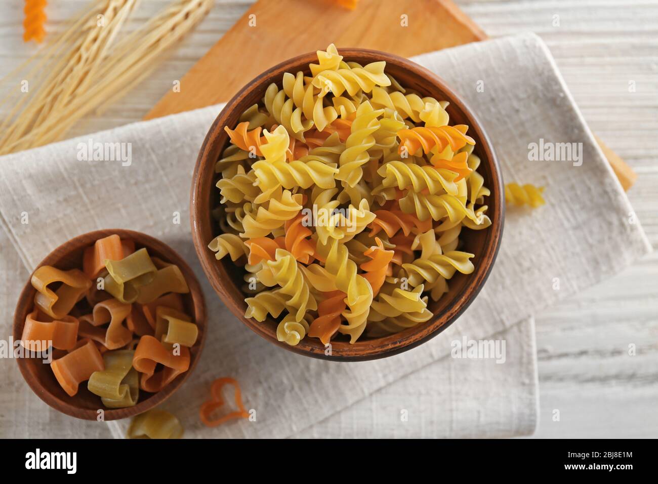 Different types of pasta on wooden table, top view Stock Photo - Alamy