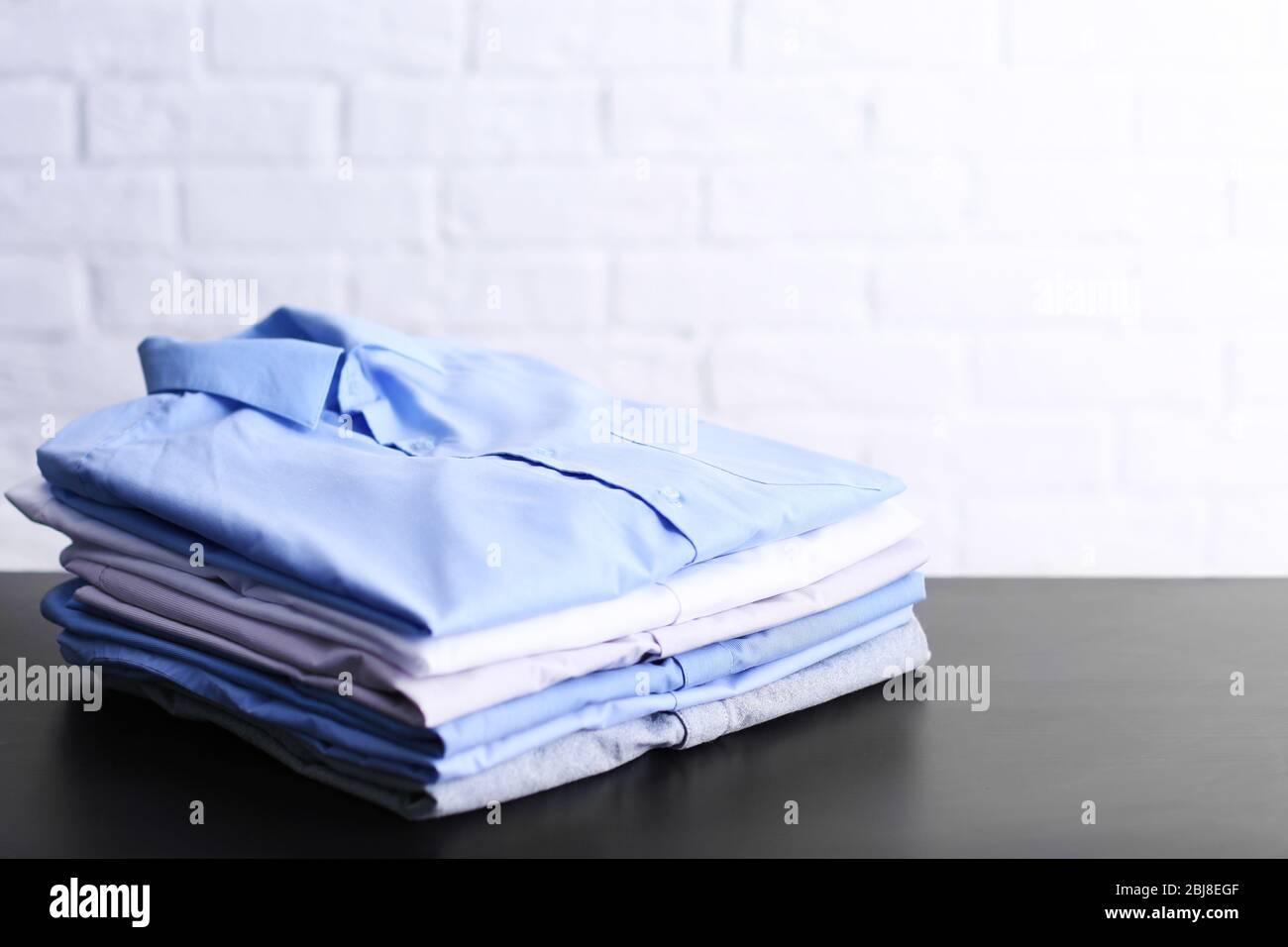 Clean male clothes on table Stock Photo - Alamy
