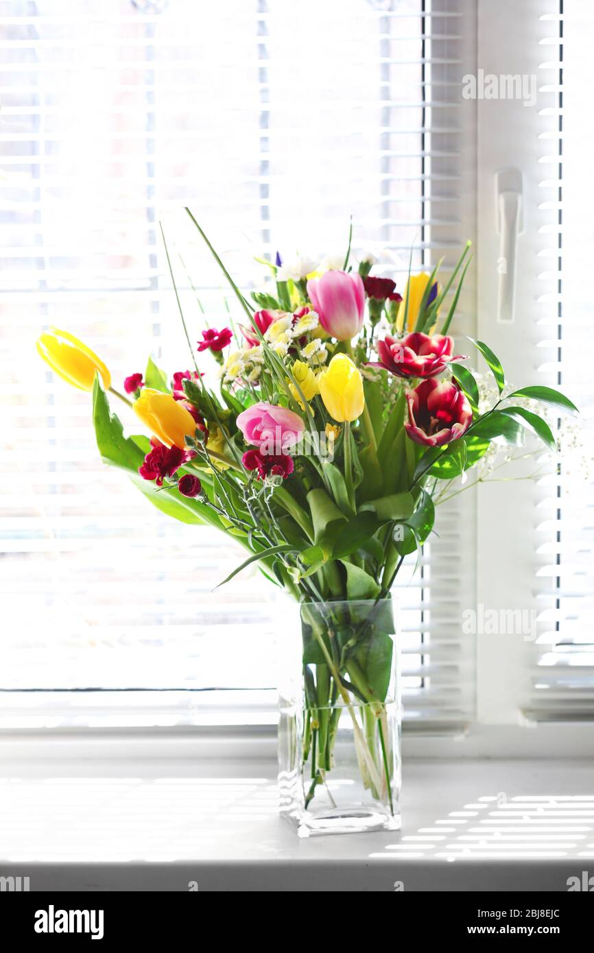 Bouquet of fresh flowers by the window Stock Photo - Alamy