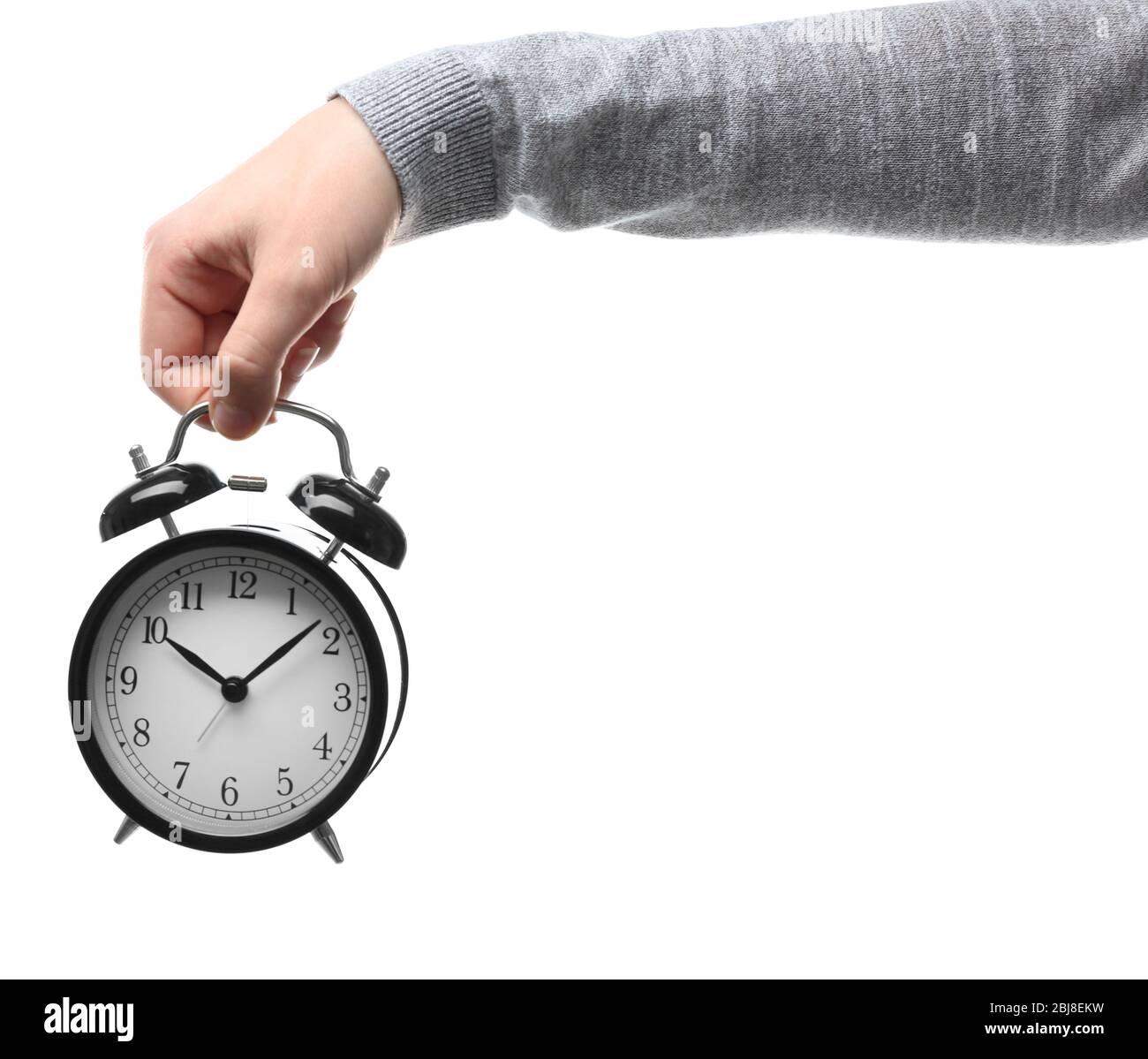 Human's hand holds an alarm-clock, isolated on white Stock Photo - Alamy