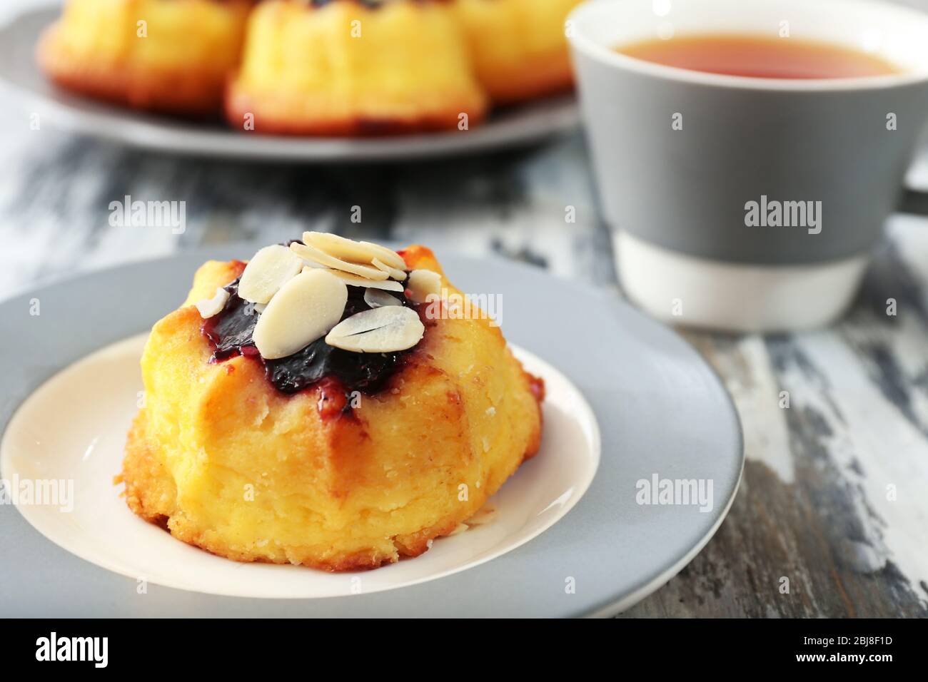 Tea with cakes on wooden background Stock Photo - Alamy