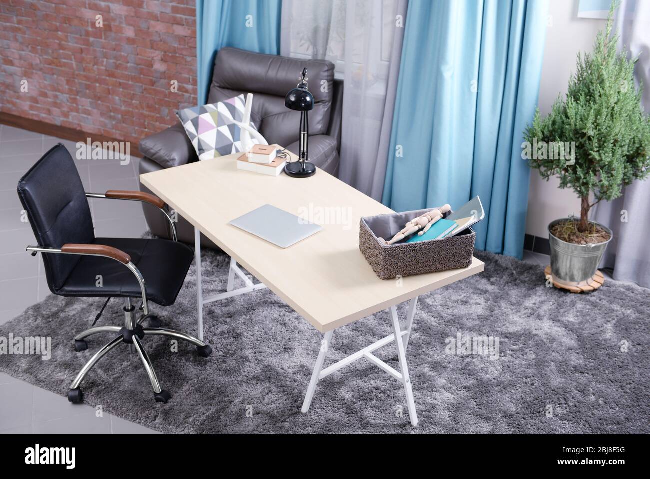 Workplace with table, office chair and laptop in living room Stock ...