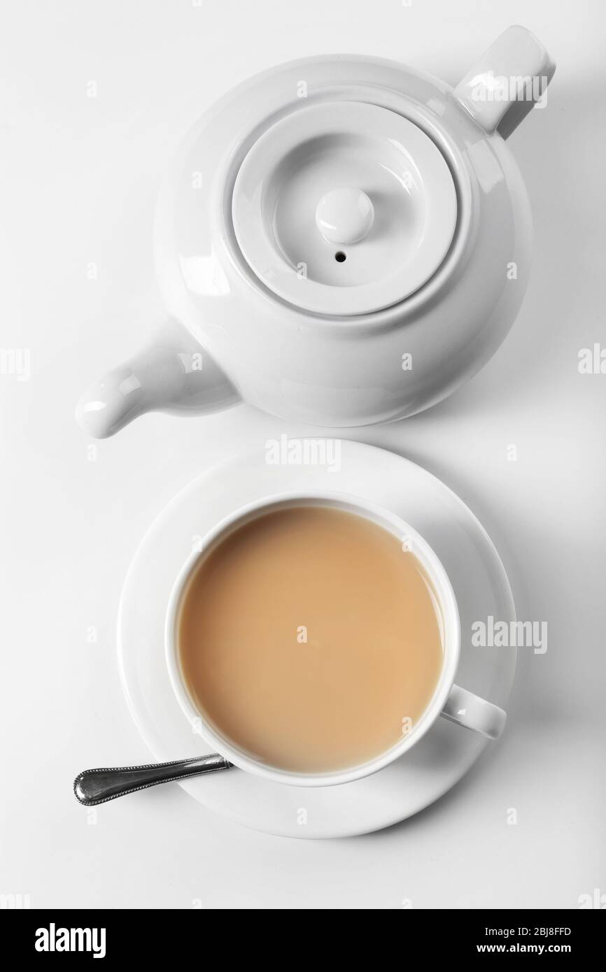 Milk tea with tea pot on white background Stock Photo - Alamy