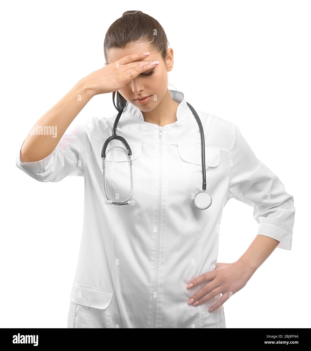 Young stressed female doctor, isolated on white Stock Photo - Alamy