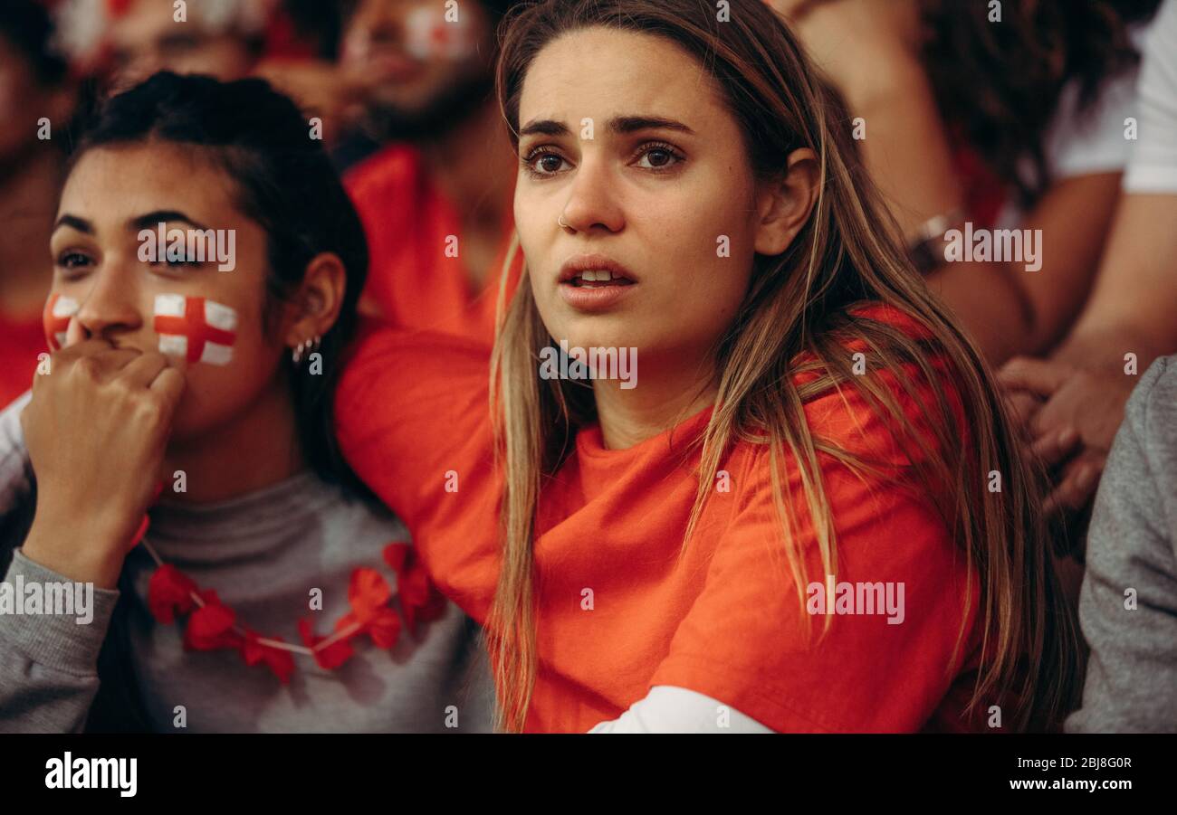 Anxious England team supporter watching a live match from stadium ...