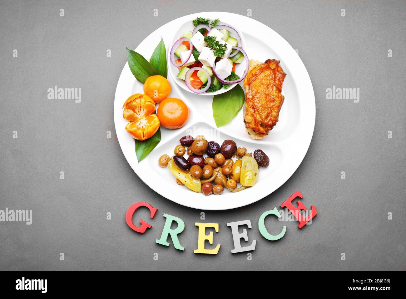 Traditional Greek lunch on brown background Stock Photo - Alamy