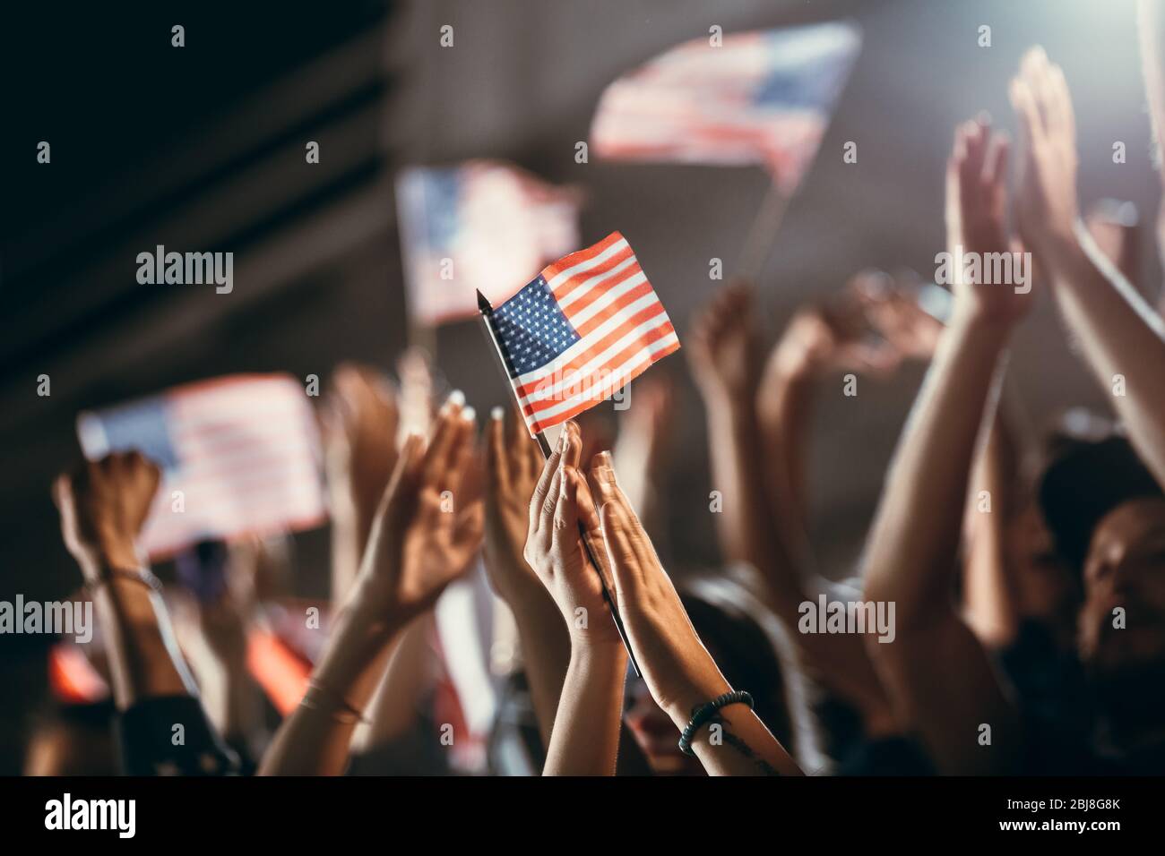 Soccer supporters with USA flags cheering on team success. Group of ...