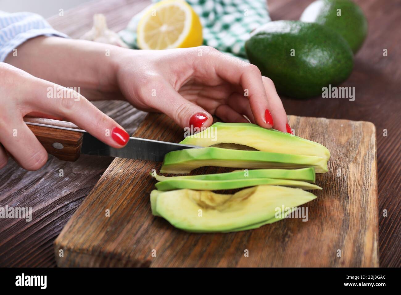 Woman hands cutting lemon slices hi-res stock photography and images ...
