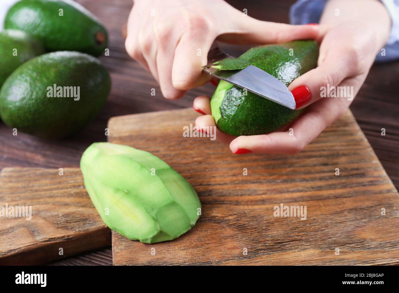 Hands holding half avocado fruit hi-res stock photography and images ...