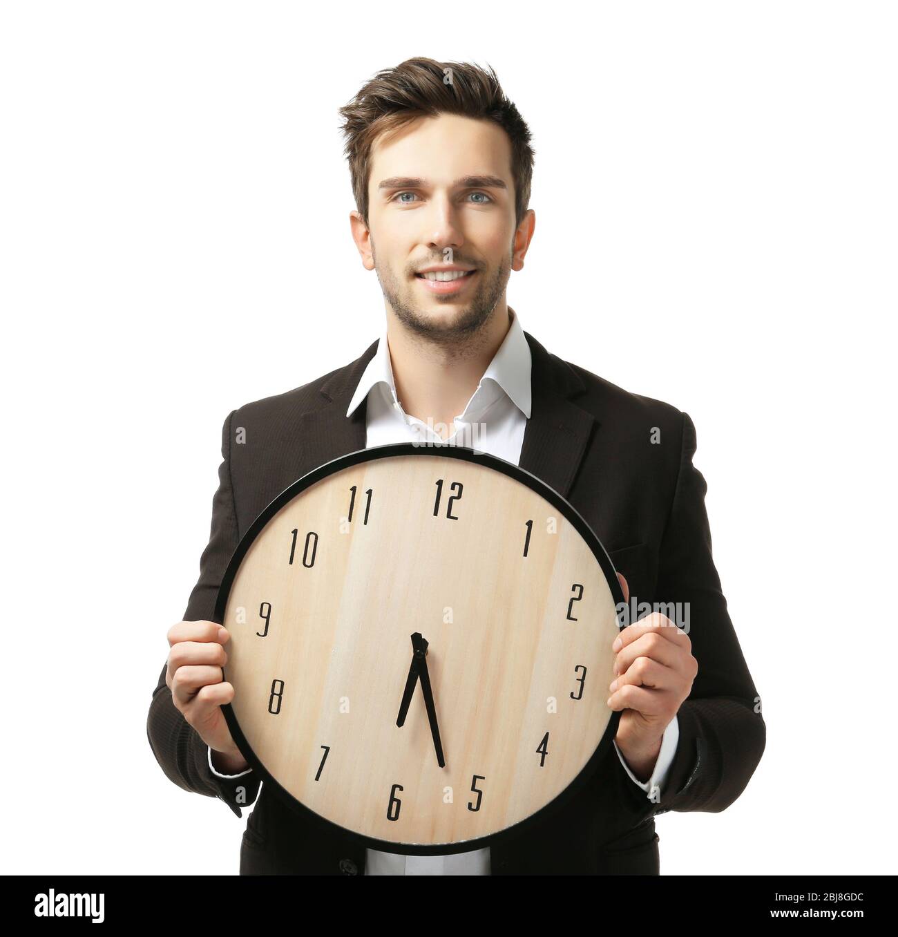 Man in black suit holding big clock on white background Stock Photo - Alamy
