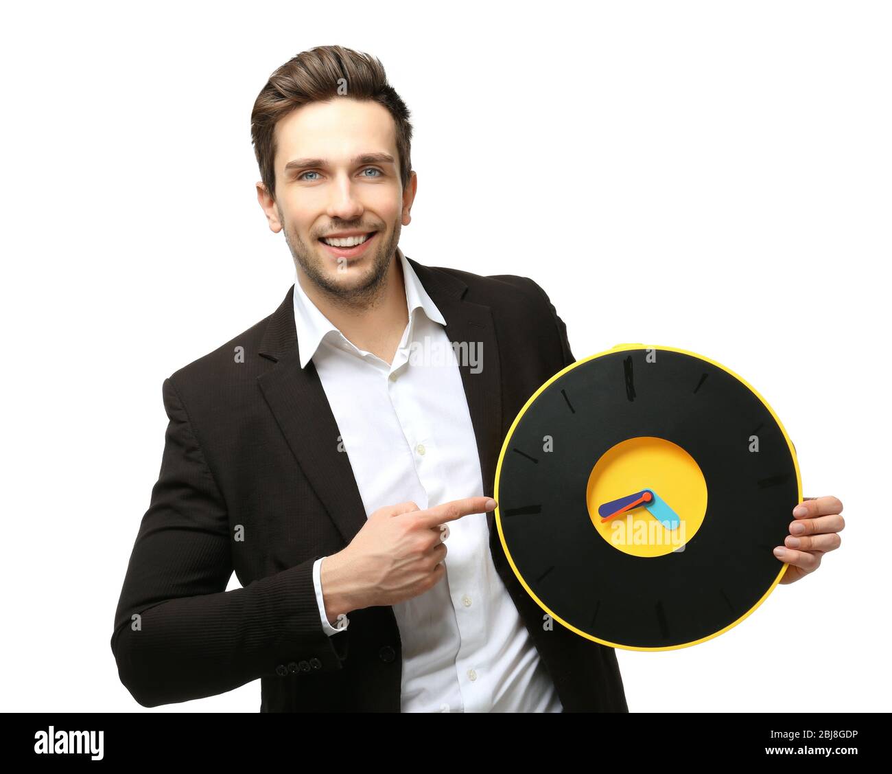 Man in black suit holding big clock on white background Stock Photo - Alamy