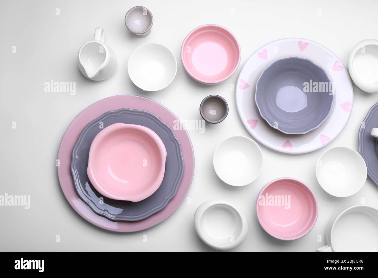 Empty colorful dishes on white background Stock Photo - Alamy