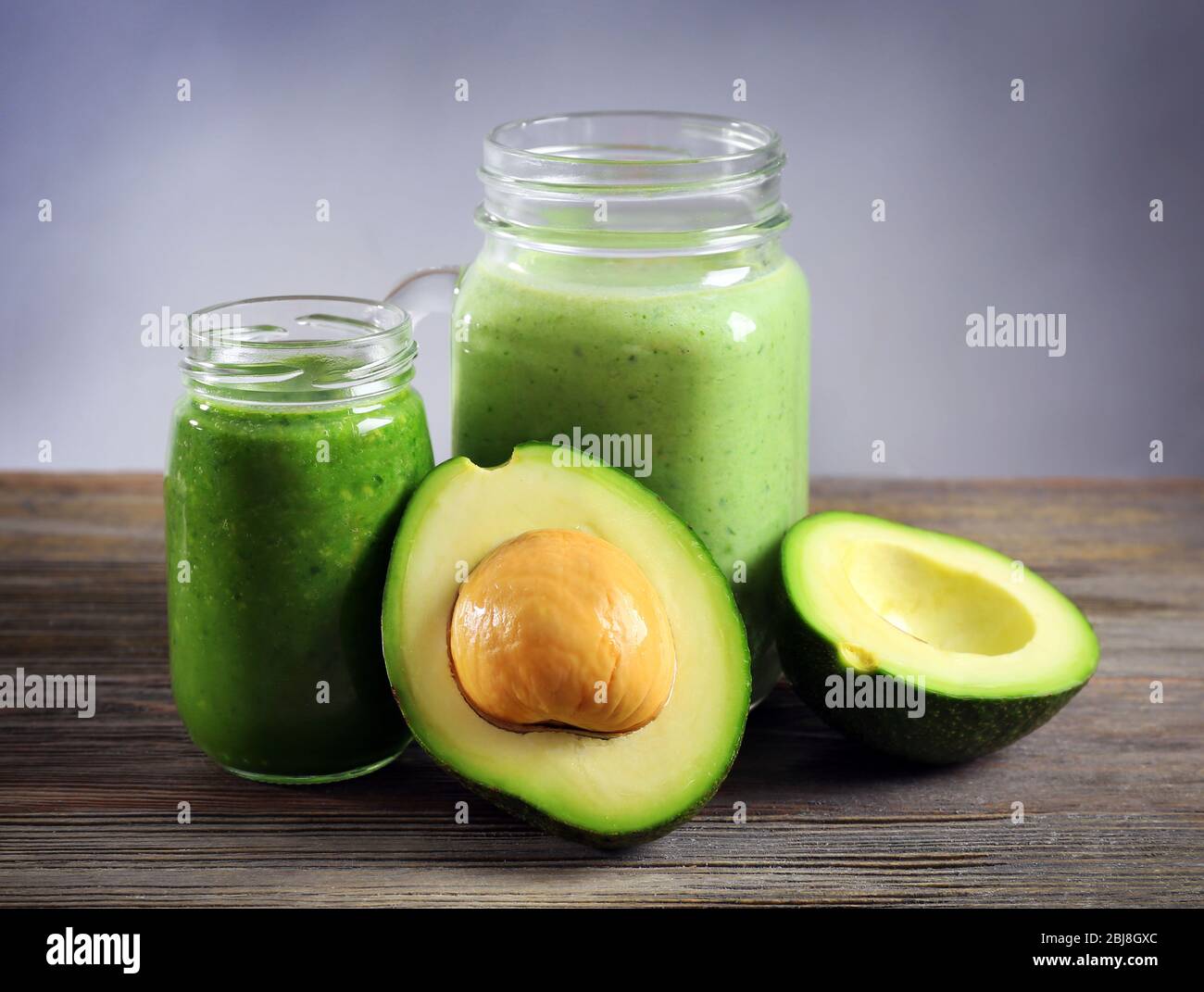 Avocado cocktail on table in front of grey background Stock Photo - Alamy