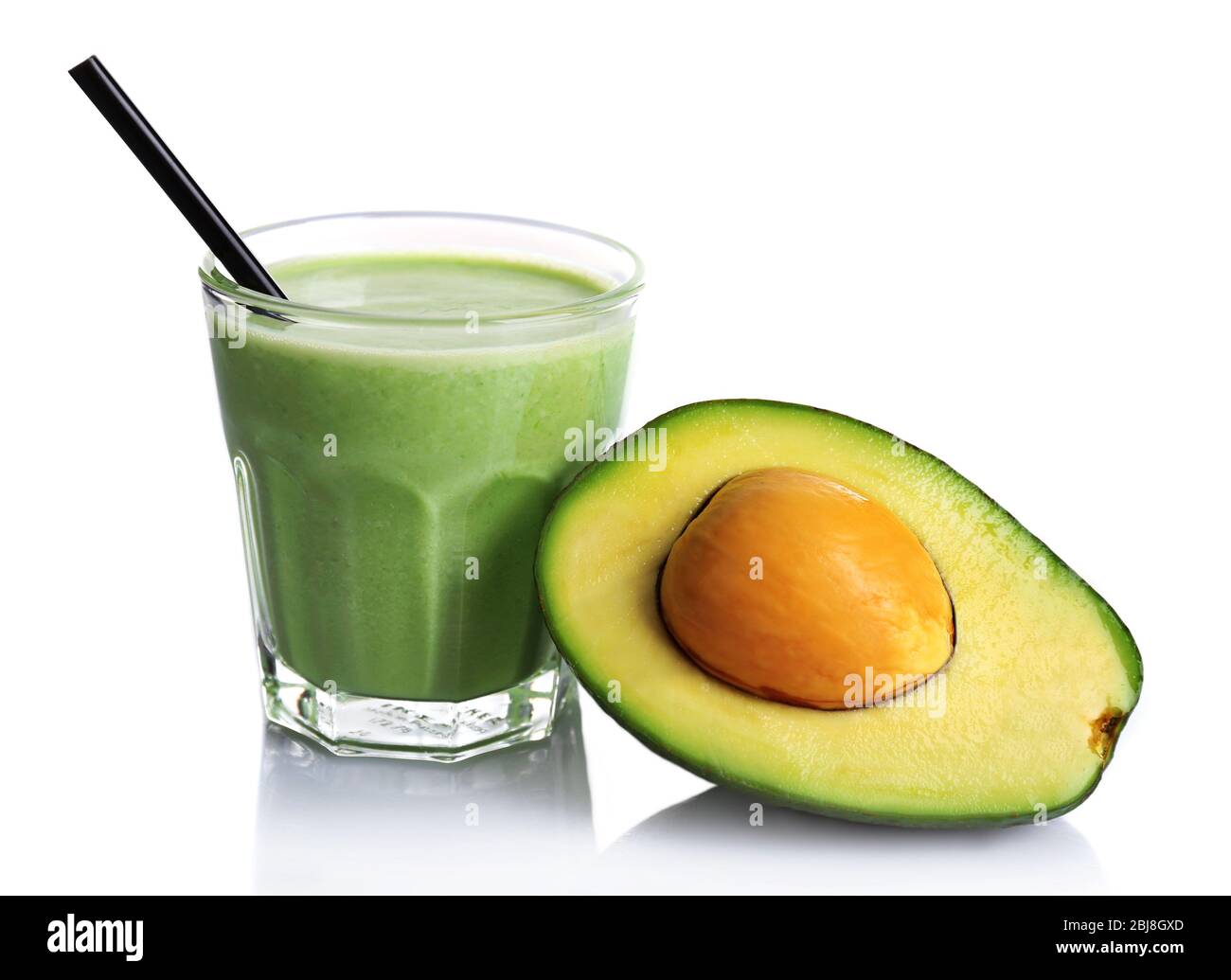 Glass of fresh avocado smoothie and avocado fruit isolated on white ...