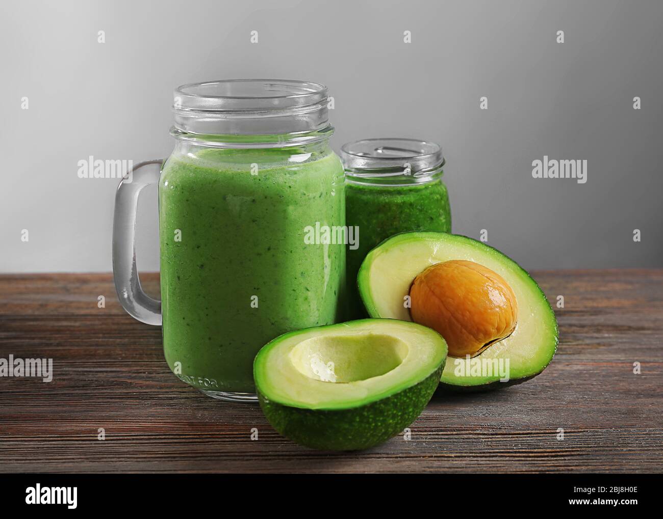 Avocado cocktail on table in front of grey background Stock Photo - Alamy