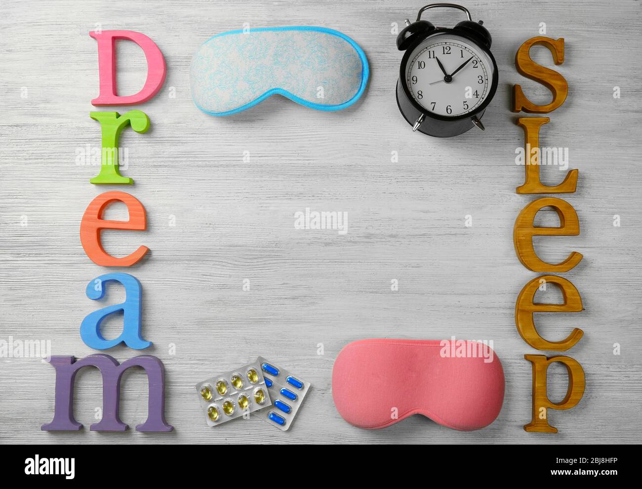 Insomnia concept. Sleeping accessories on wooden table, top view Stock ...