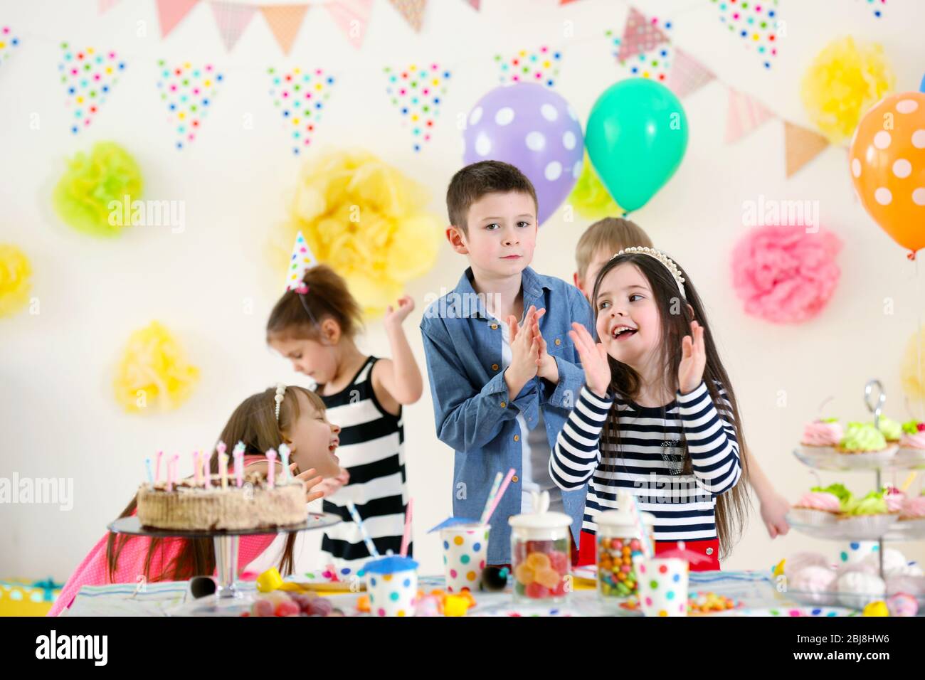 Happy group of children dancing at birthday party Stock Photo - Alamy