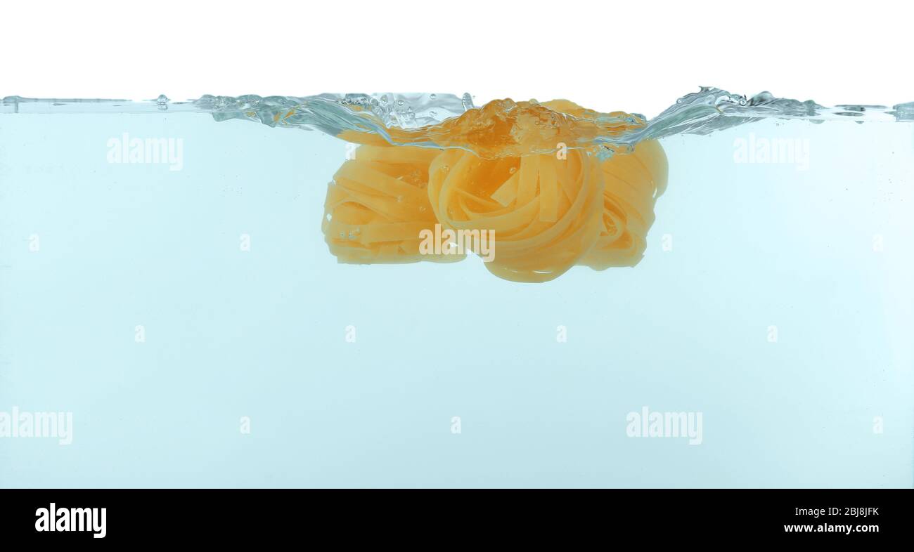 Noodles falling in water Stock Photo - Alamy