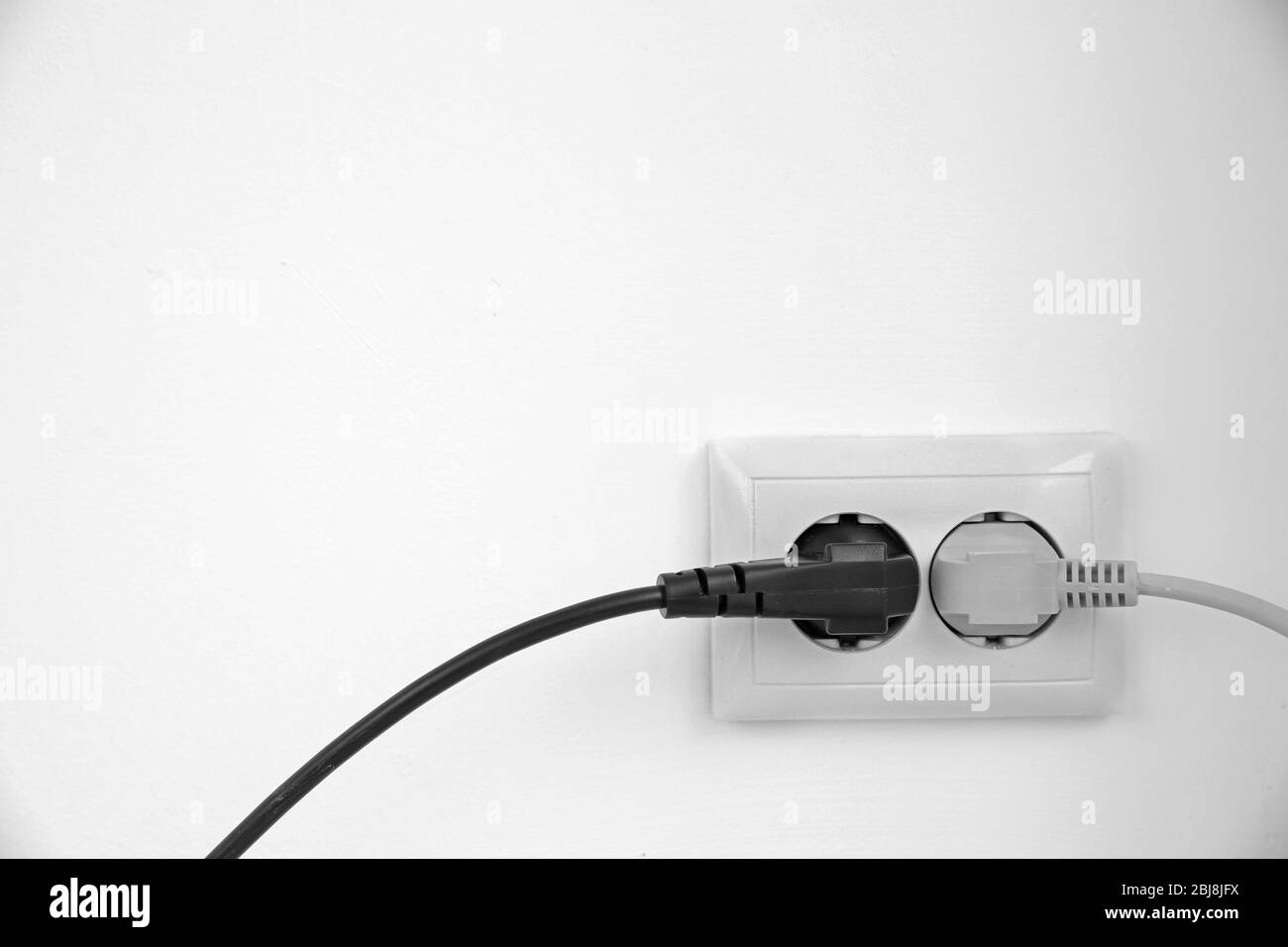 Electric plug in socket Stock Photo - Alamy