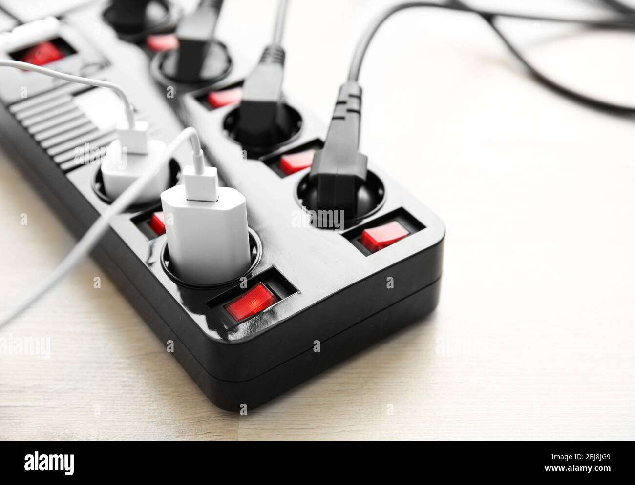 Loaded power strip Stock Photo - Alamy