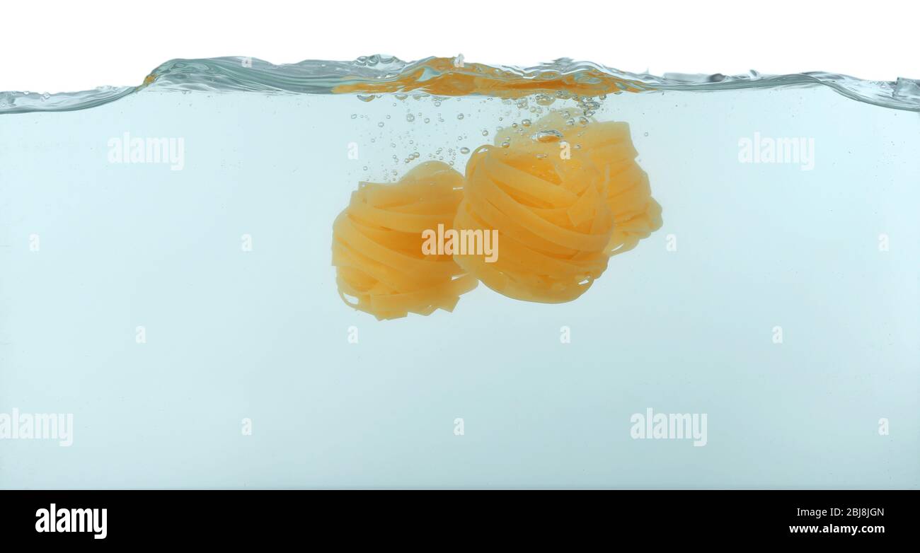 Noodles falling in water Stock Photo - Alamy
