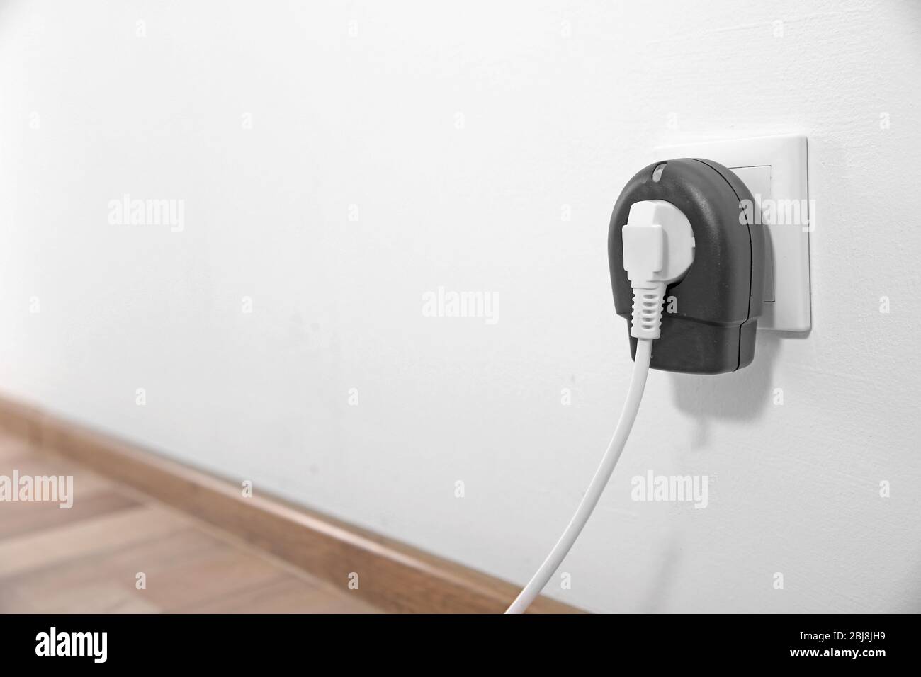 Electric plug in socket Stock Photo - Alamy