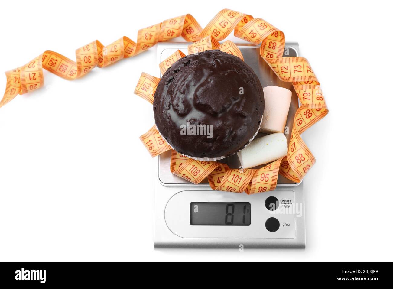 Chocolate cupcake with marshmallow and centimeter on digital kitchen ...