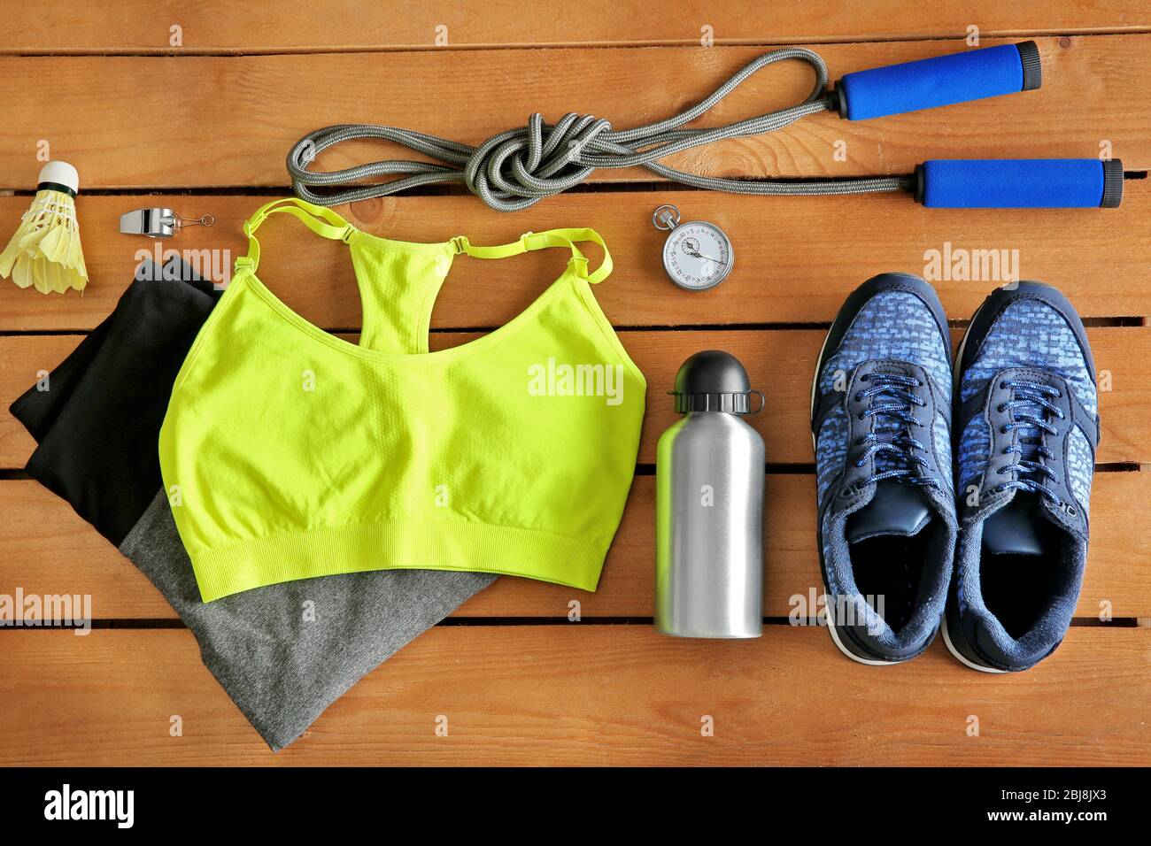 Sport equipment and clothes on wooden background Stock Photo - Alamy