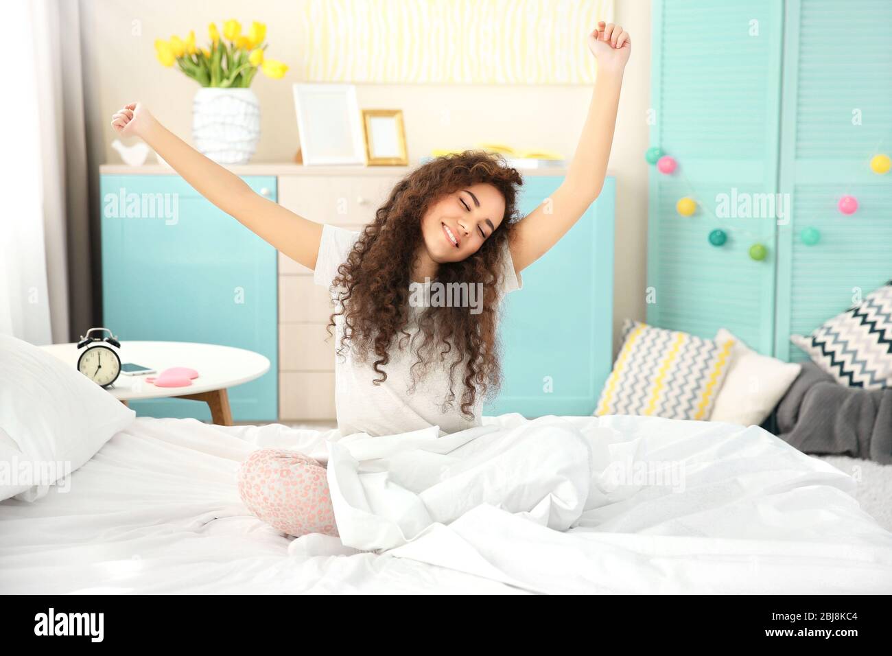 Girl stretching after wake up Stock Photo - Alamy