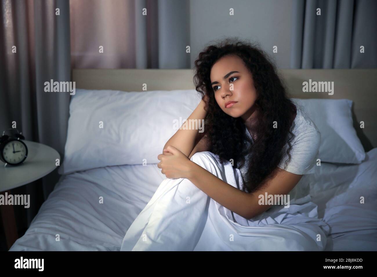 Tired beautiful girl in bed Stock Photo - Alamy