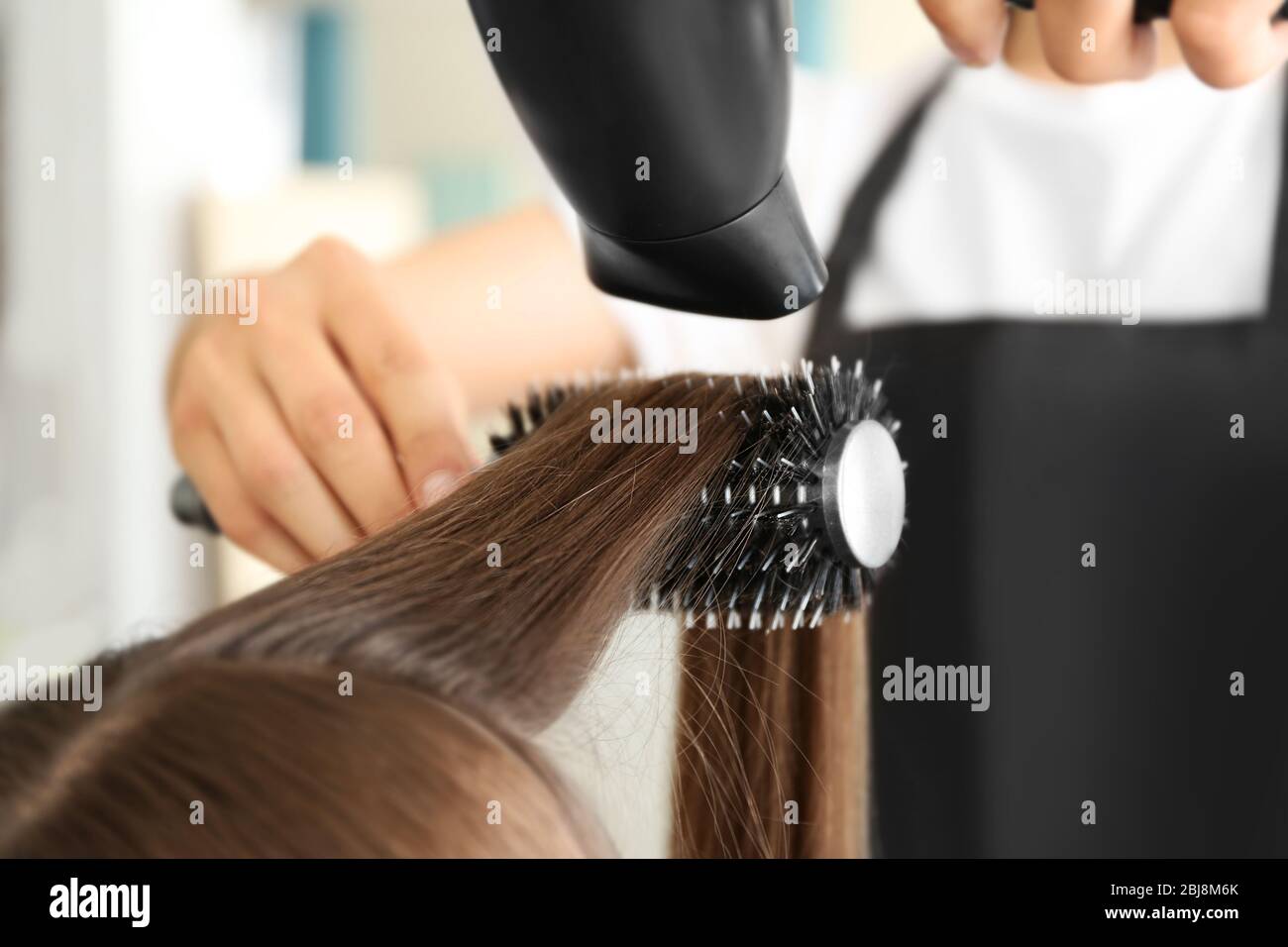 Professional hairdresser drying hair Stock Photo - Alamy