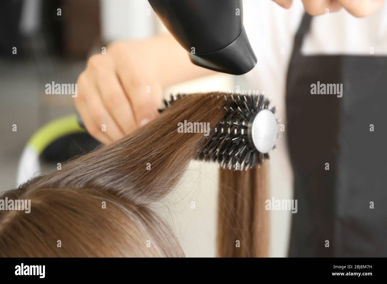Professional hairdresser drying hair Stock Photo - Alamy