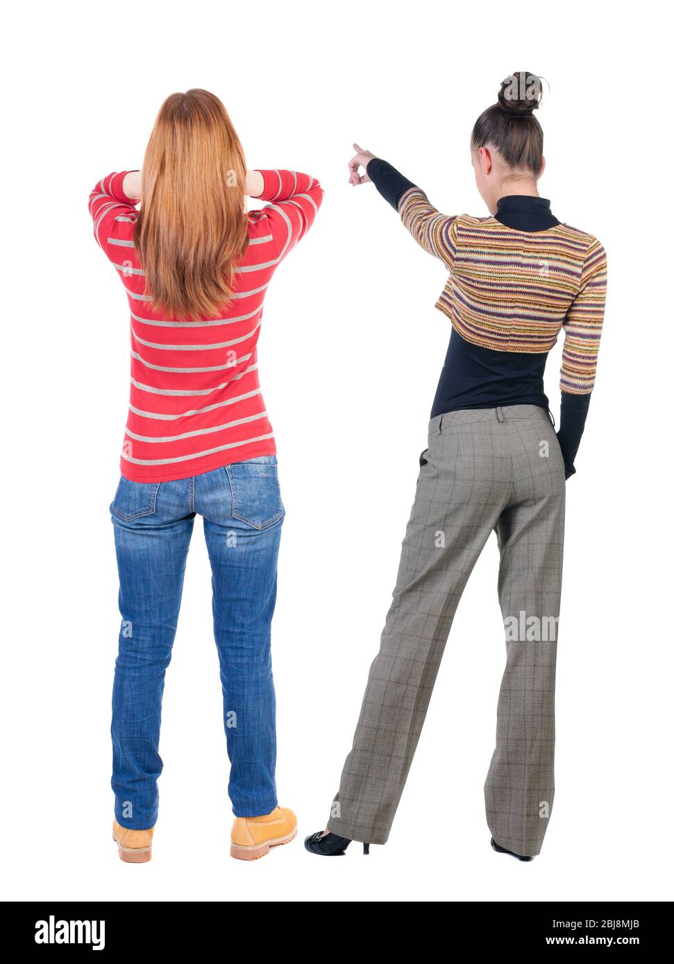 Back view of two pointing girl in sweater. Rear view people collection ...