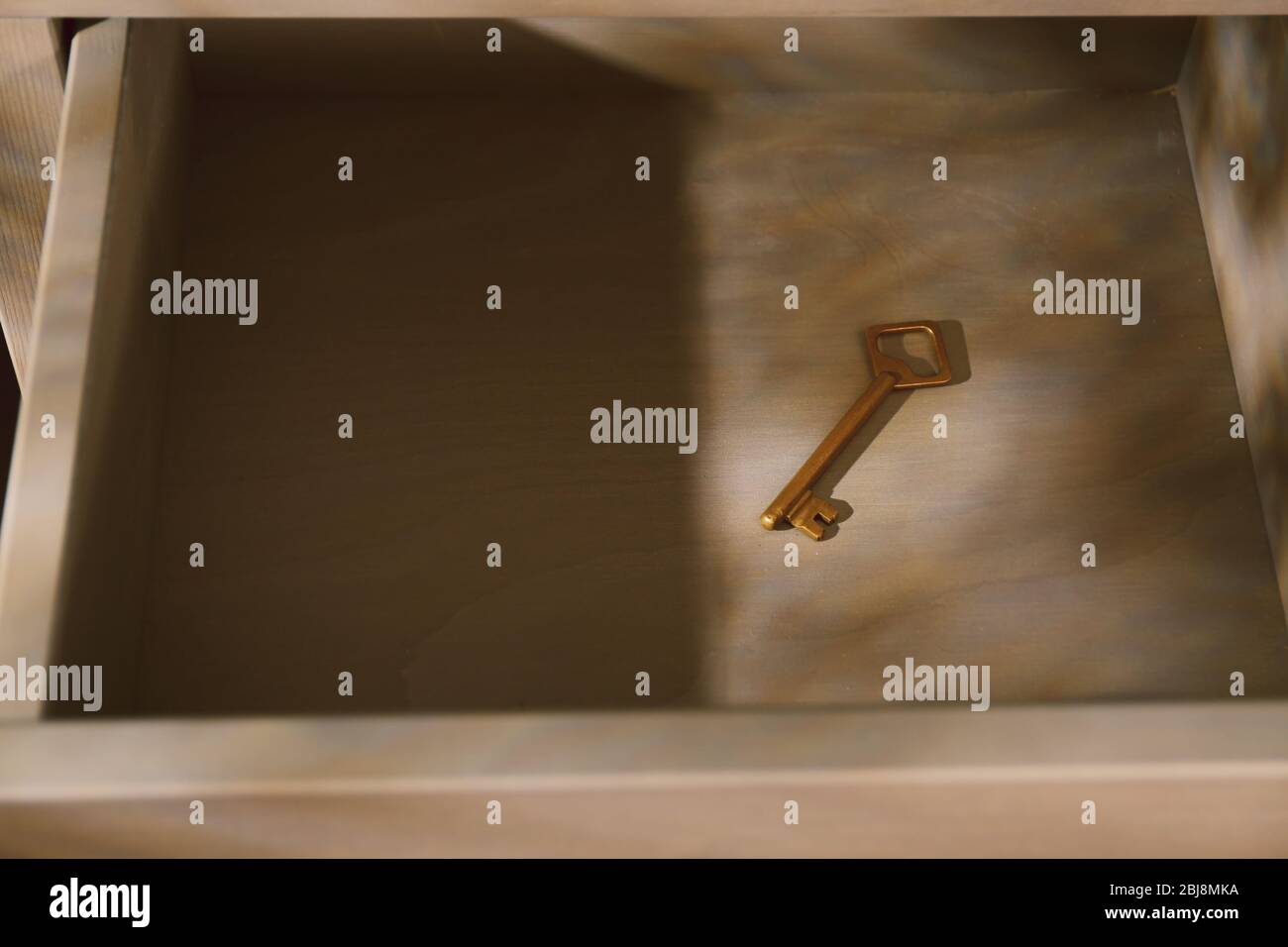 Golden key in drawer Stock Photo - Alamy