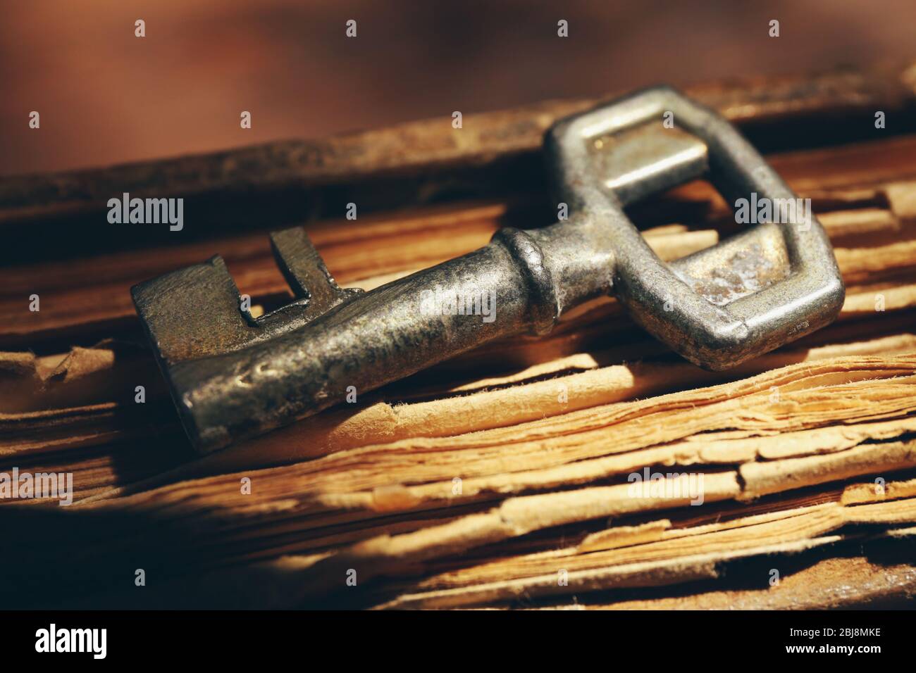 Key on old book, close up Stock Photo - Alamy