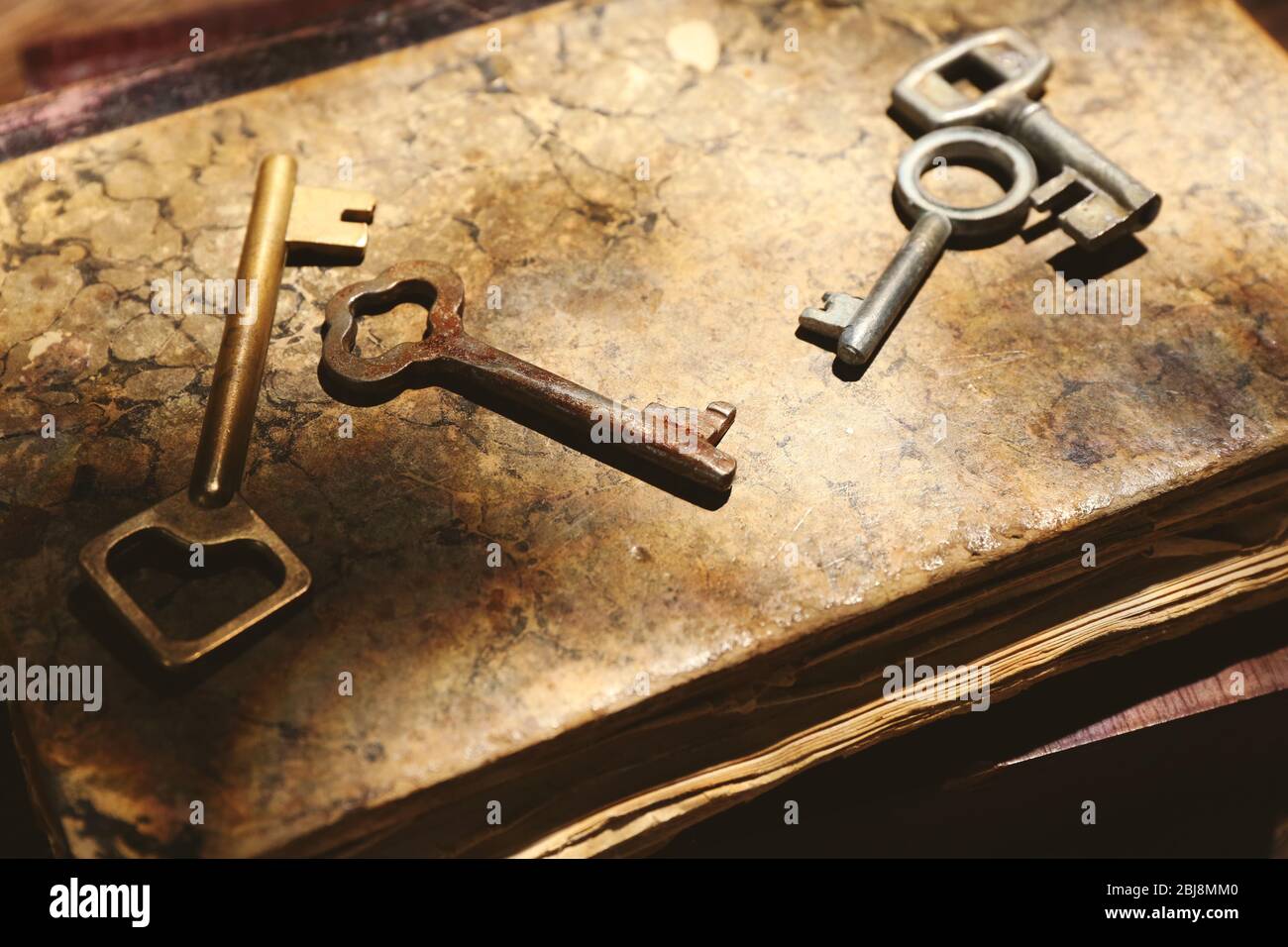 Four keys on background of old books Stock Photo - Alamy