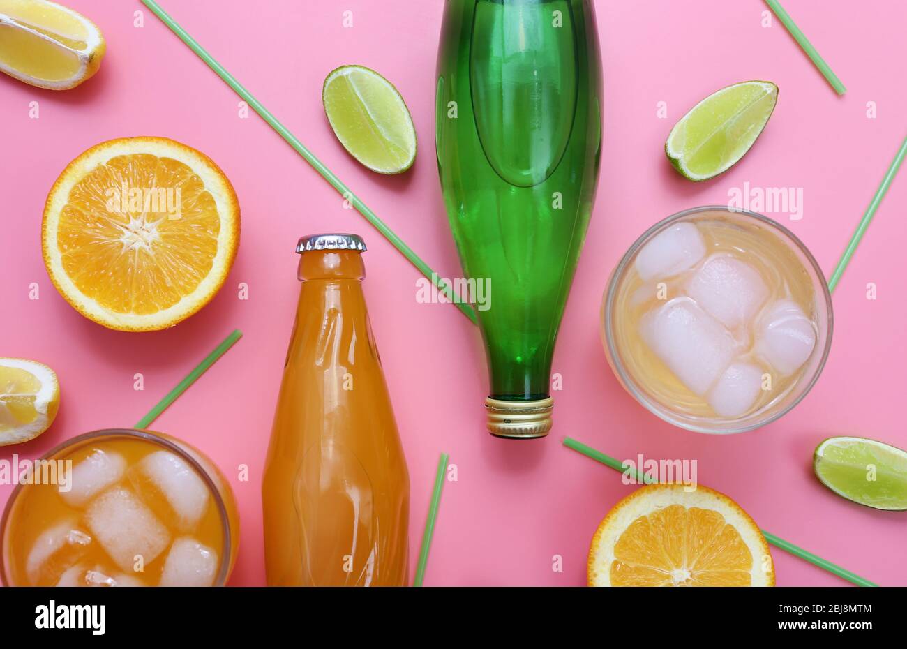 Different fruit drinks with fresh fruits on pink background Stock Photo ...