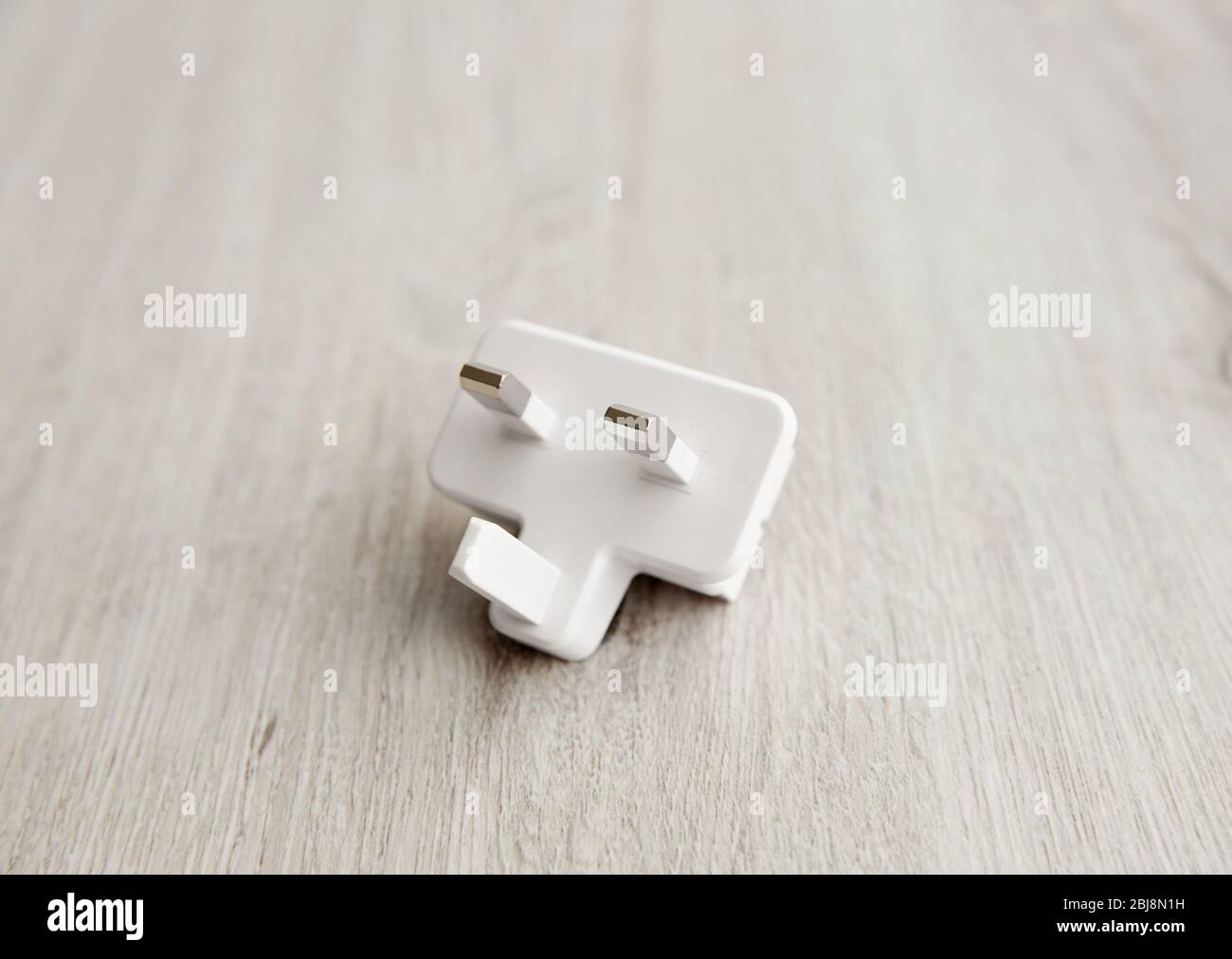 Electrical power adapter on wooden background Stock Photo - Alamy