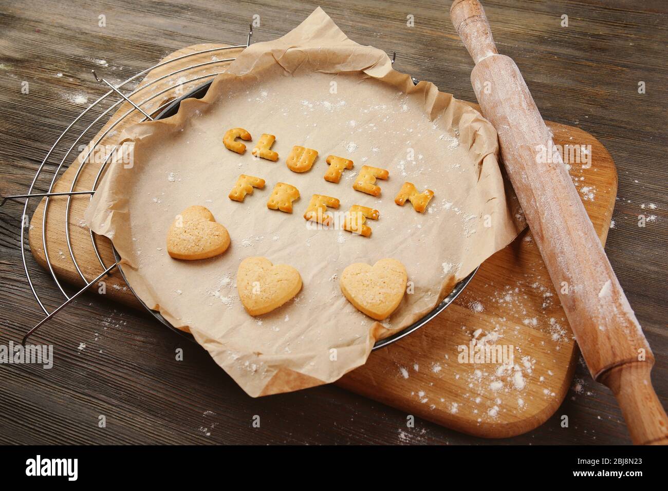 Gluten free made of crackers on parchment over wooden table Stock Photo ...