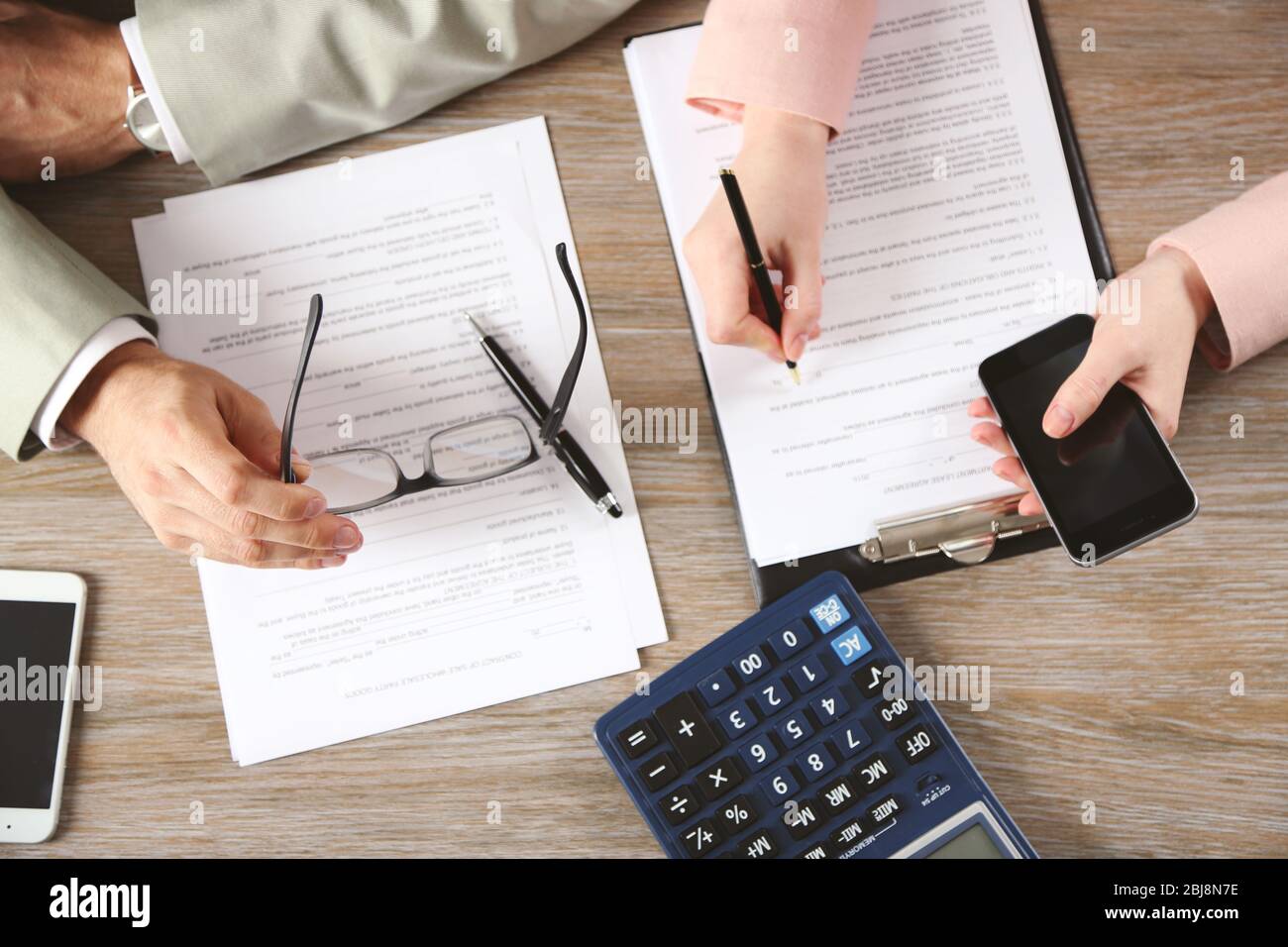 Human hands working with documents at the desk, top view Stock Photo ...