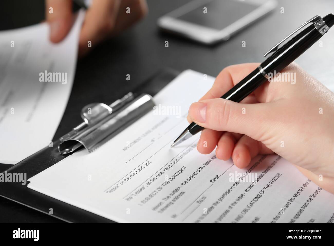 Black woman signing documents hi-res stock photography and images - Alamy