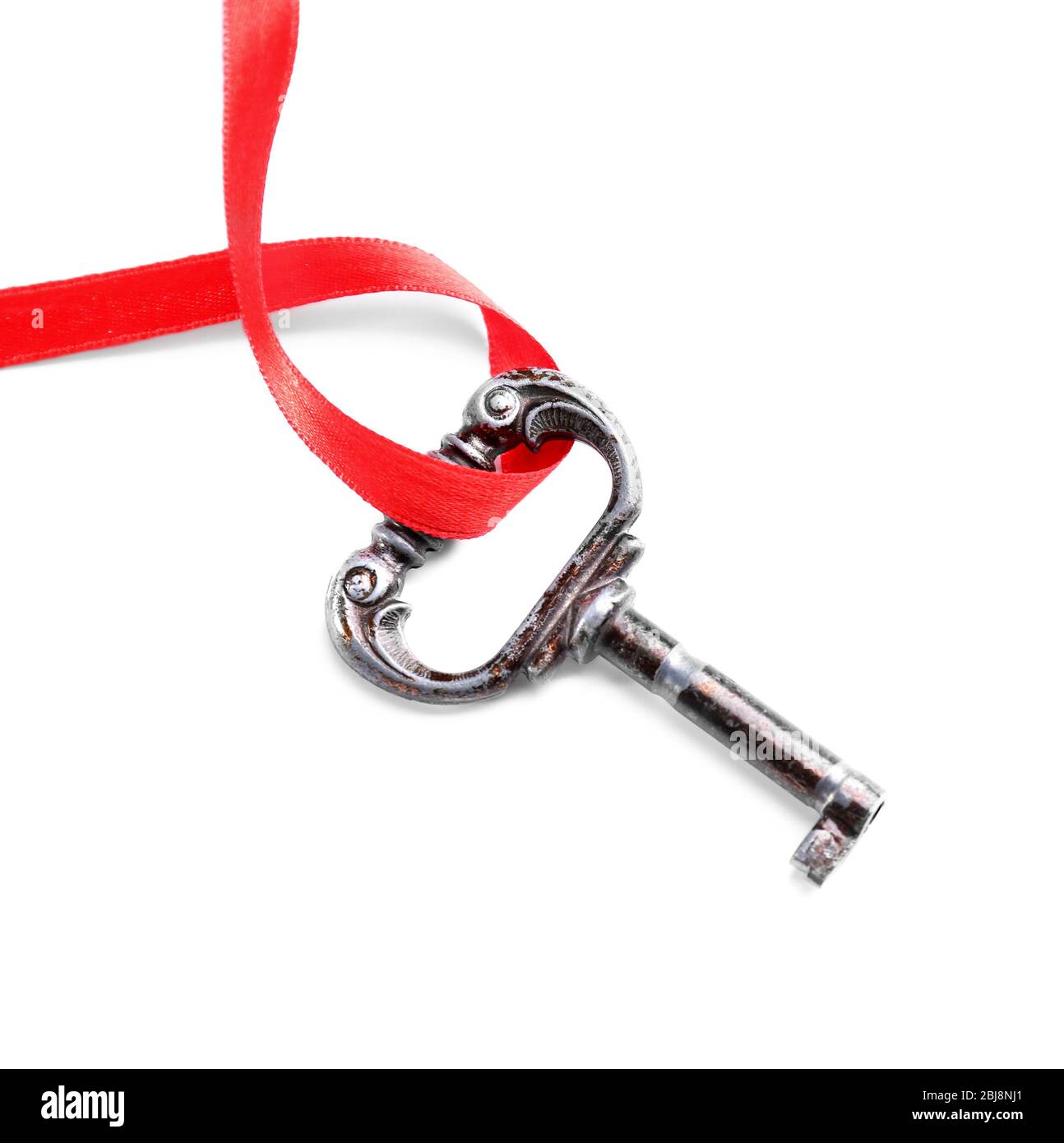 Vintage key with a red ribbon on a white background Stock Photo - Alamy